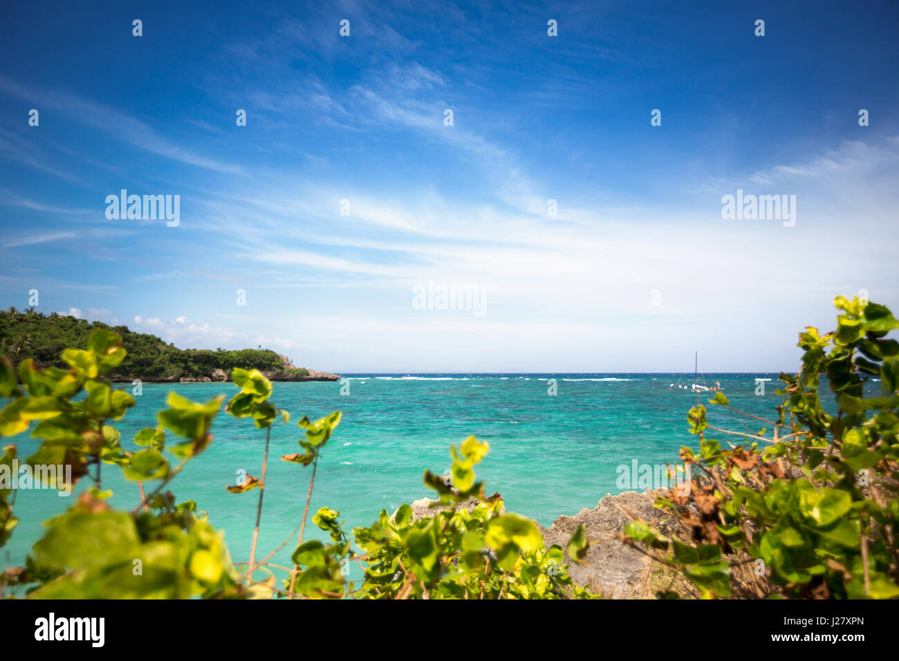 Beautiful azure sea, beach surrounded by greenery Stock Photo - Alamy