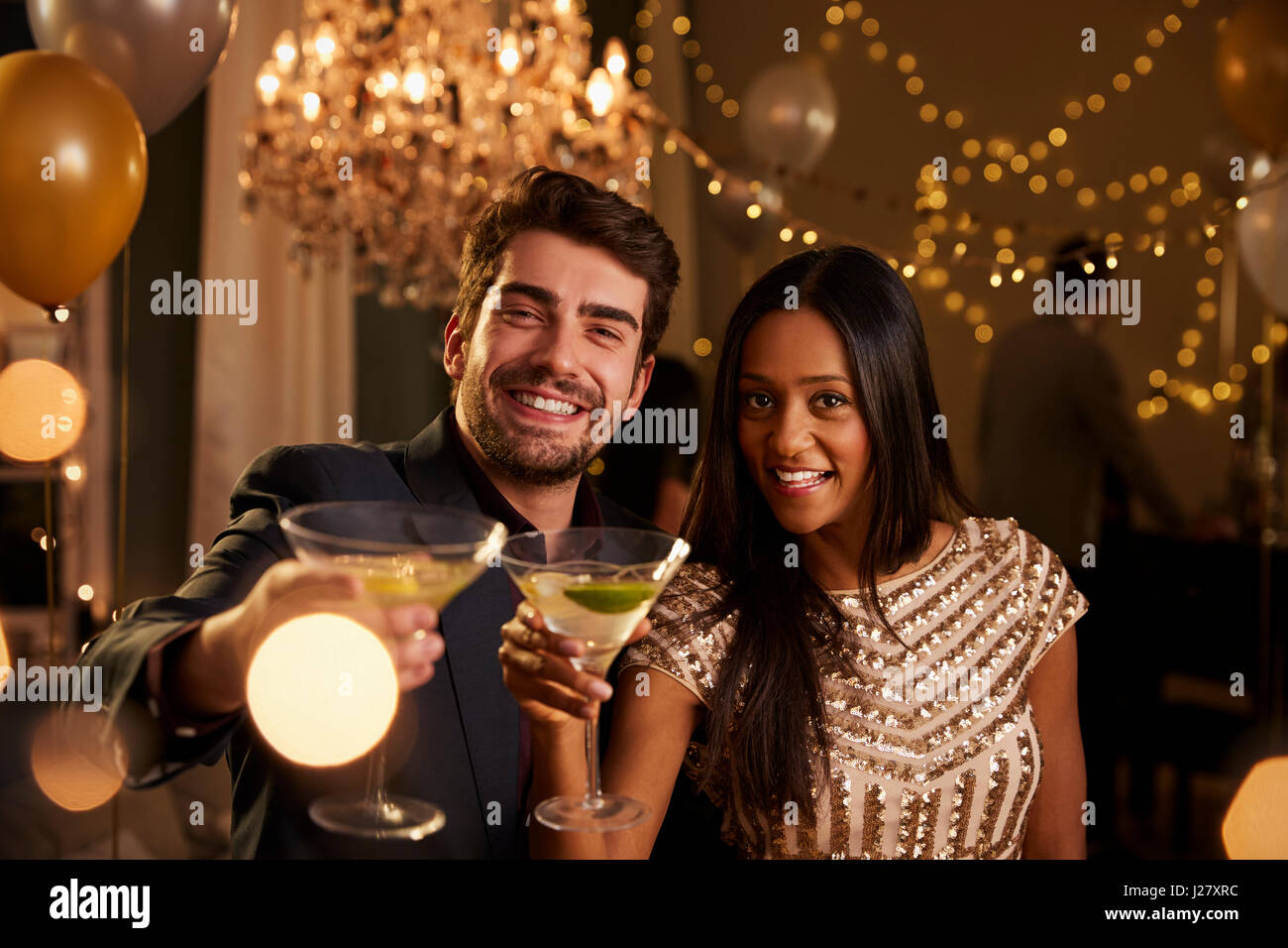 Couple Make Toast At Camera As They Celebrate At Party Stock Photo - Alamy