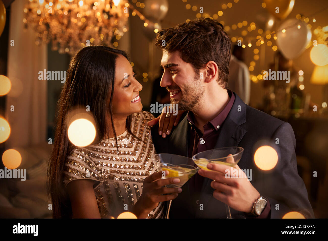 Couple Make Toast At Camera As They Celebrate At Party Stock Photo - Alamy