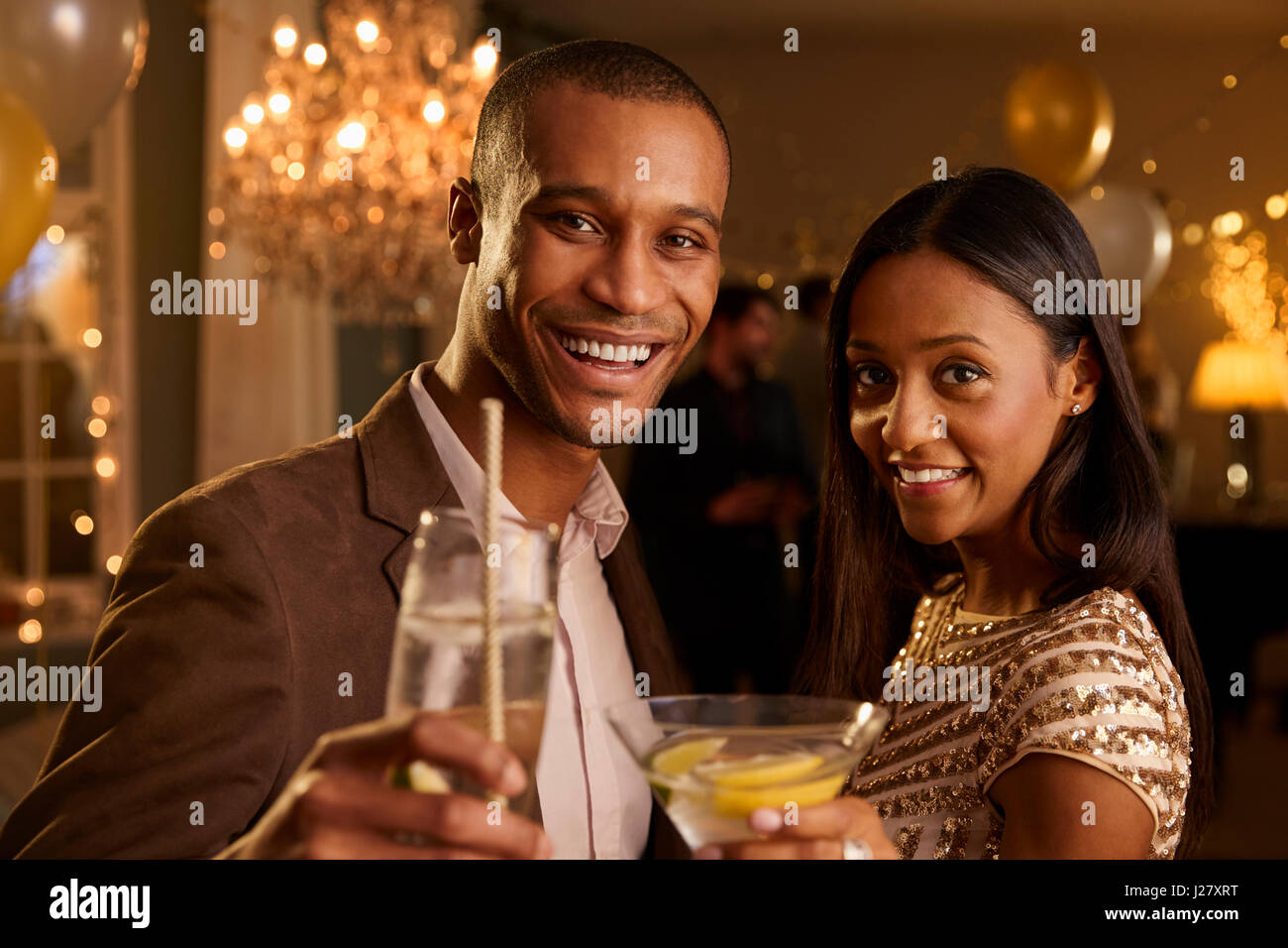 Couple Make Toast At Camera As They Celebrate At Party Stock Photo - Alamy