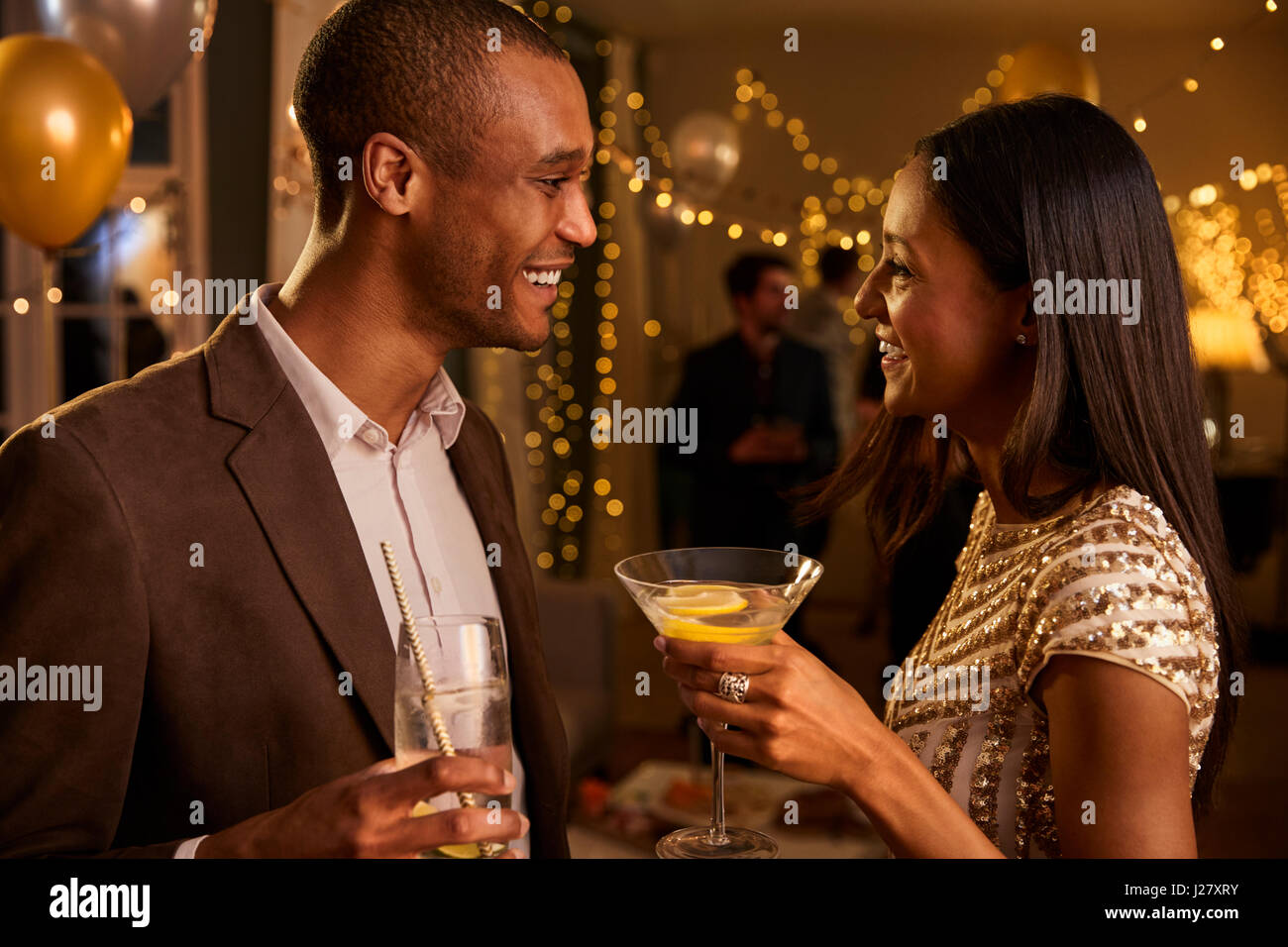 Couple Chat As They Enjoy Cocktail Party Together Stock Photo - Alamy