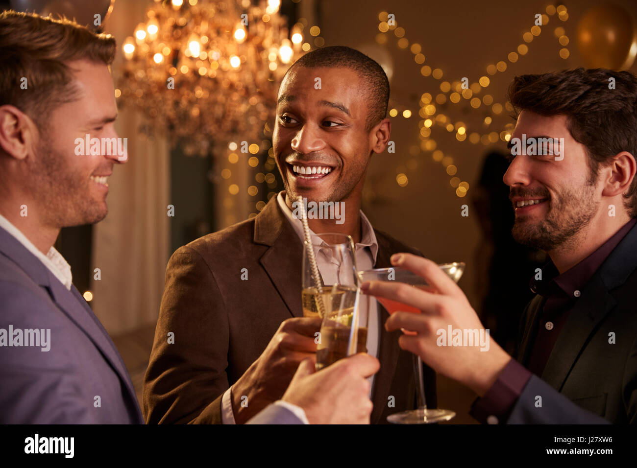 Male Friends Make Toast As They Celebrate At Party Together Stock Photo ...