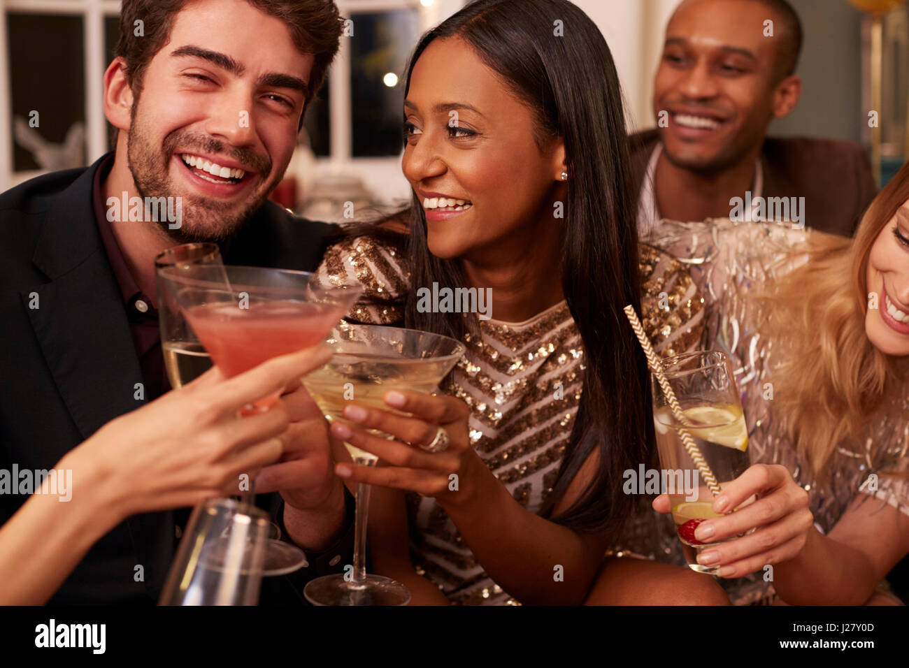 Group Of Friends With Drinks Enjoying Cocktail Party Stock Photo - Alamy