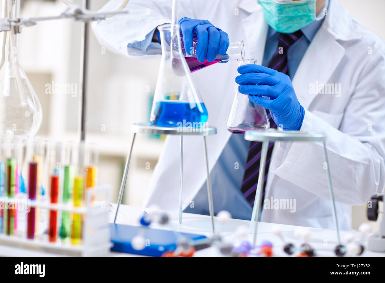 Scientist hand holding a laboratory glassware for an experiment in a ...