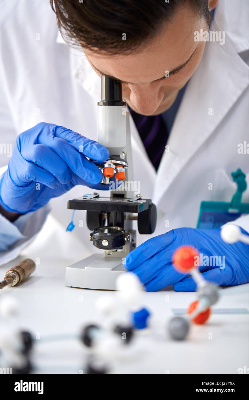 Researcher looking through a microscope hi-res stock photography and ...