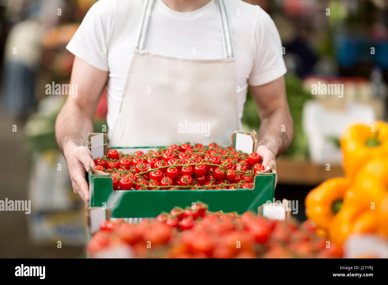 salesman holding organic cherry tomato at street market Stock Photo - Alamy