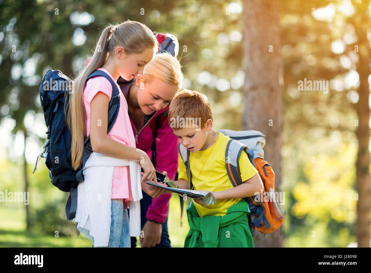 mother and children looking map on the hiking Stock Photo - Alamy