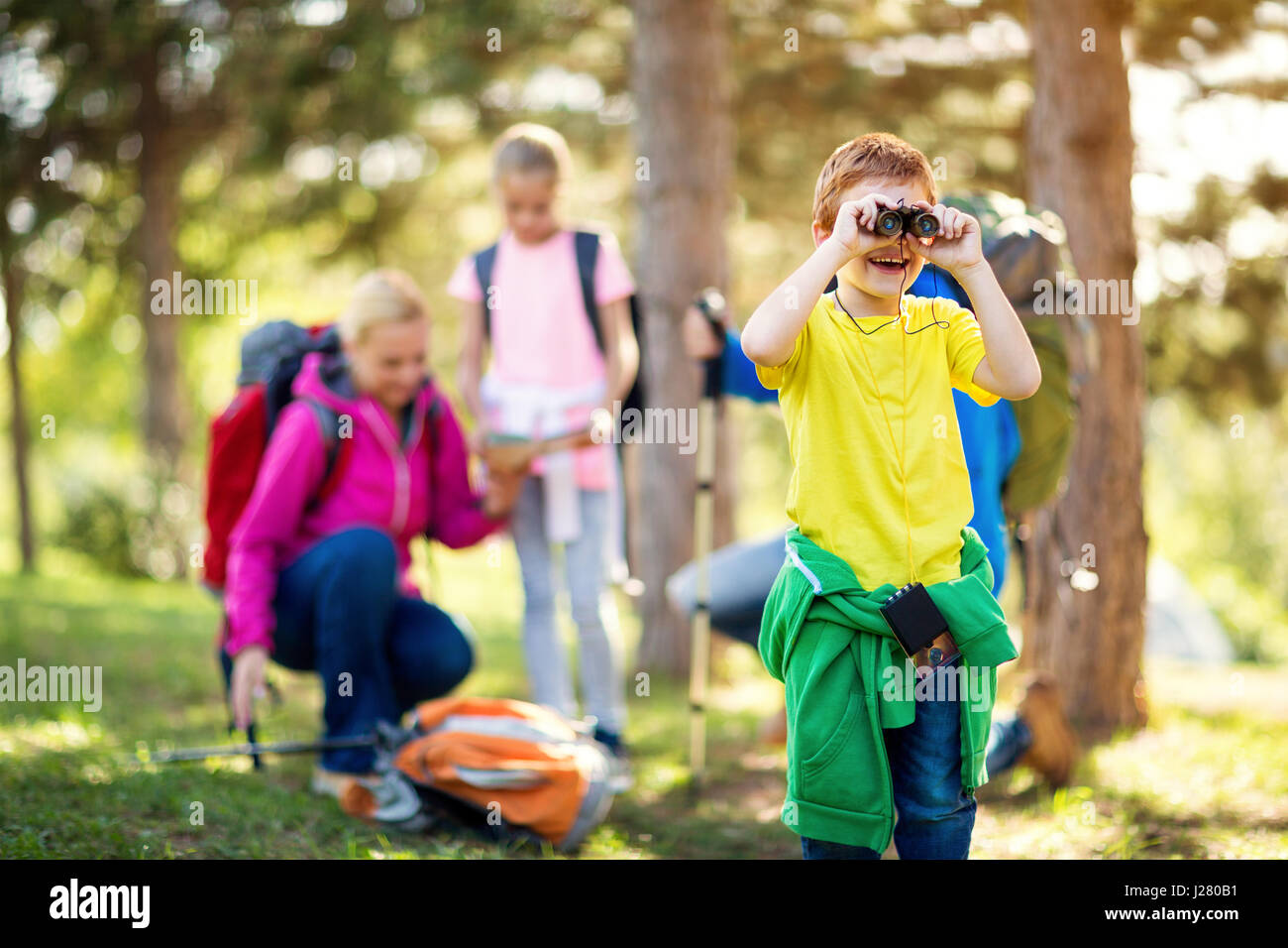 smiling child looking through binocular in nature Stock Photo - Alamy