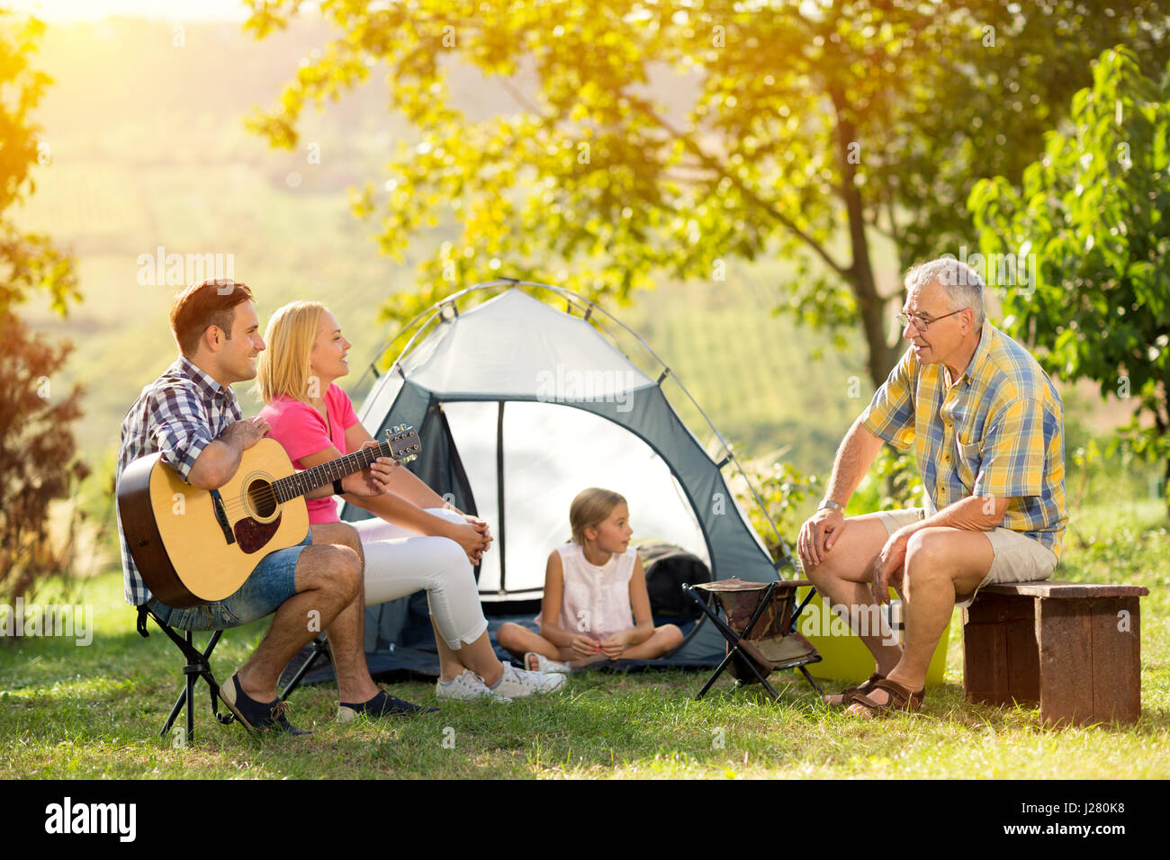 happy family camping at countryside with tent Stock Photo - Alamy