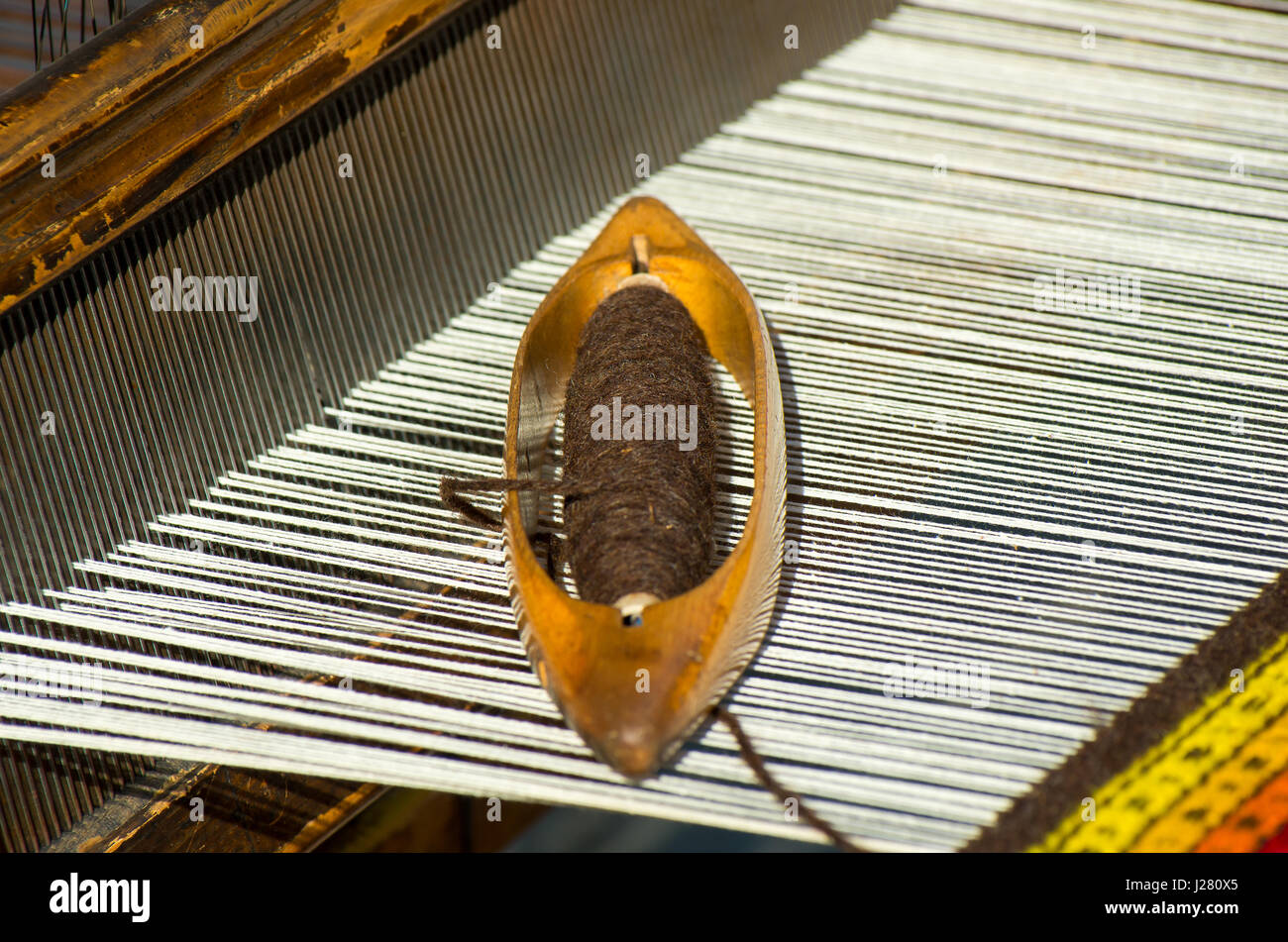 Crafts. Hand loom with many colorful woolen threads Stock Photo - Alamy
