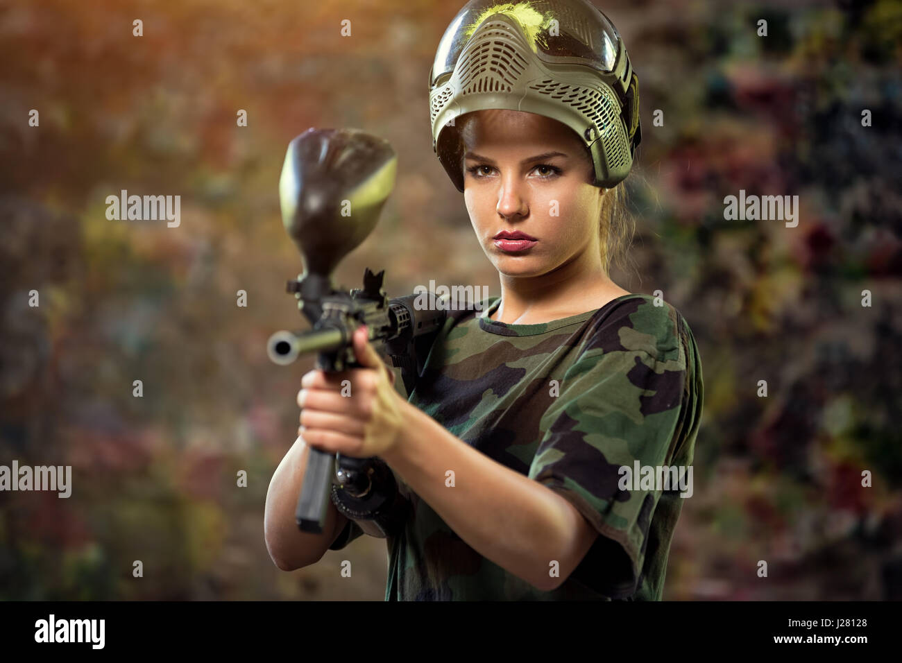 attractive female paintball targeting with gun Stock Photo - Alamy