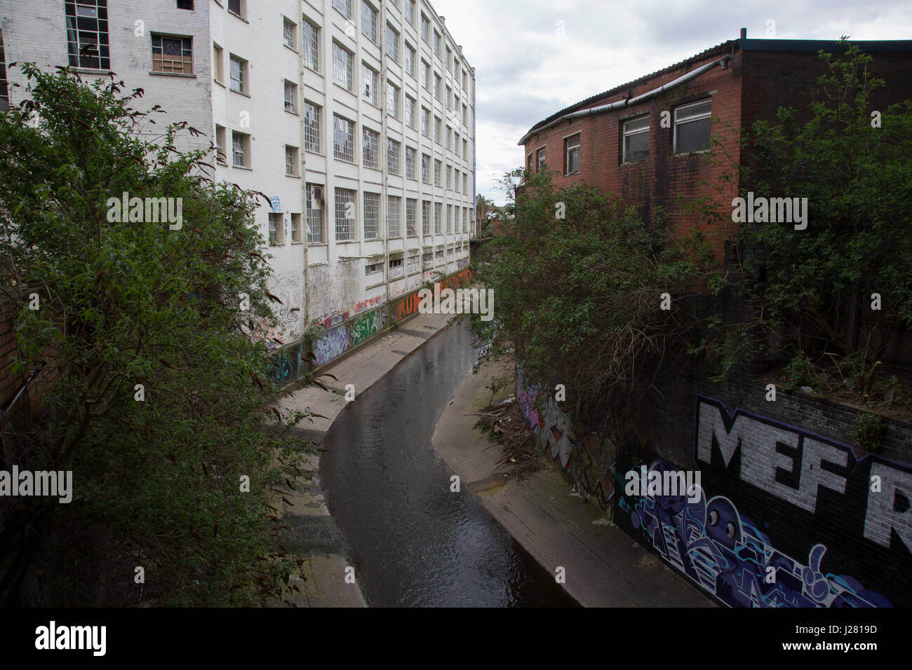 Street art graffiti along the canal system River Rea in Digbeth ...