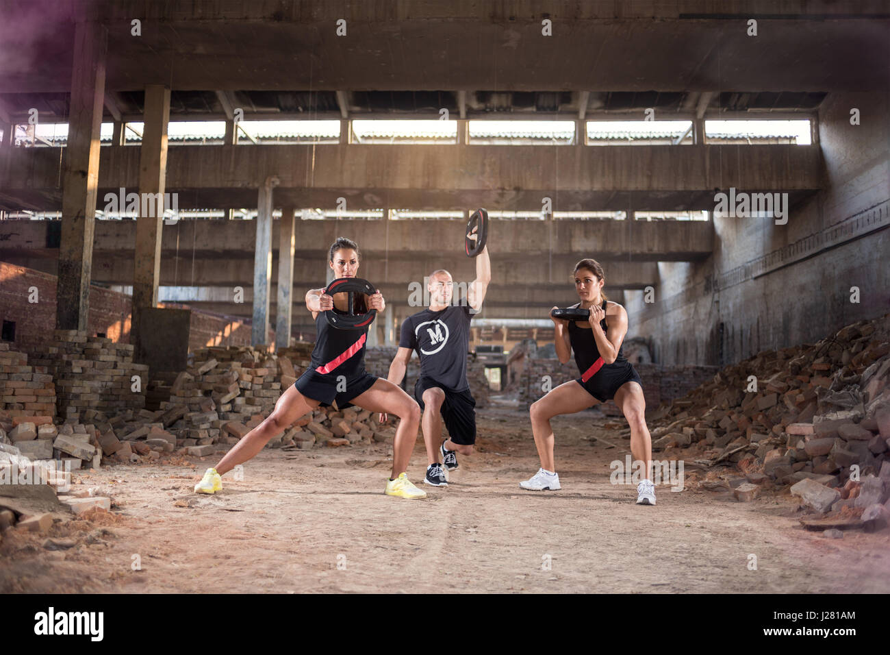 Active sport people has condition training with weights in hangar Stock ...