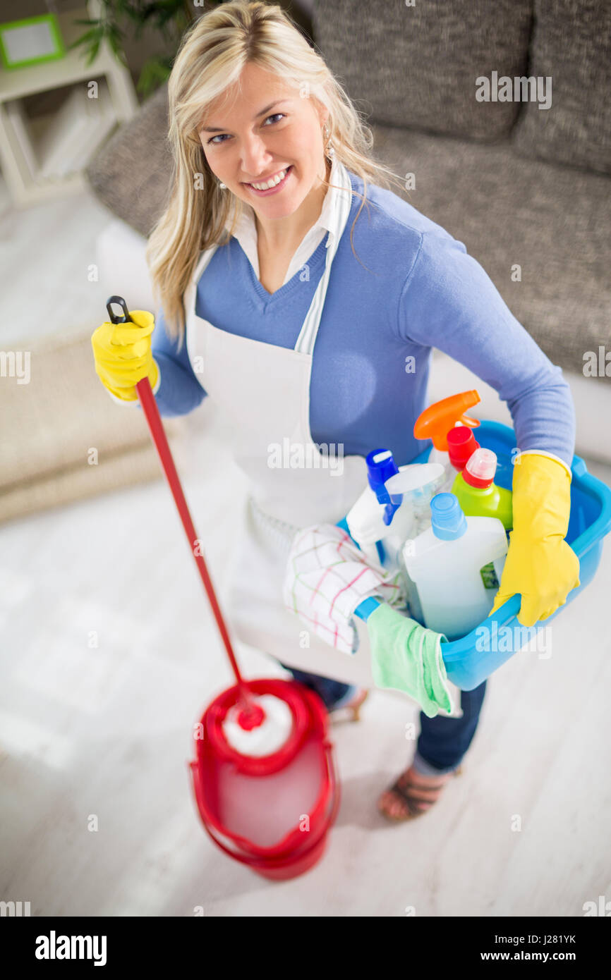 Young pretty housewife prepared to clean Stock Photo - Alamy