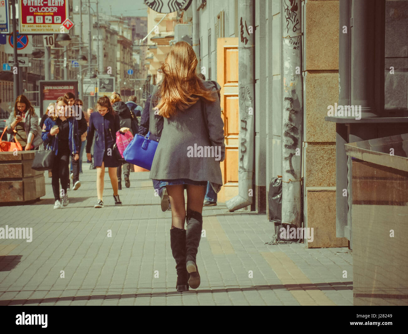Beautiful girl walking down the street Stock Photo - Alamy