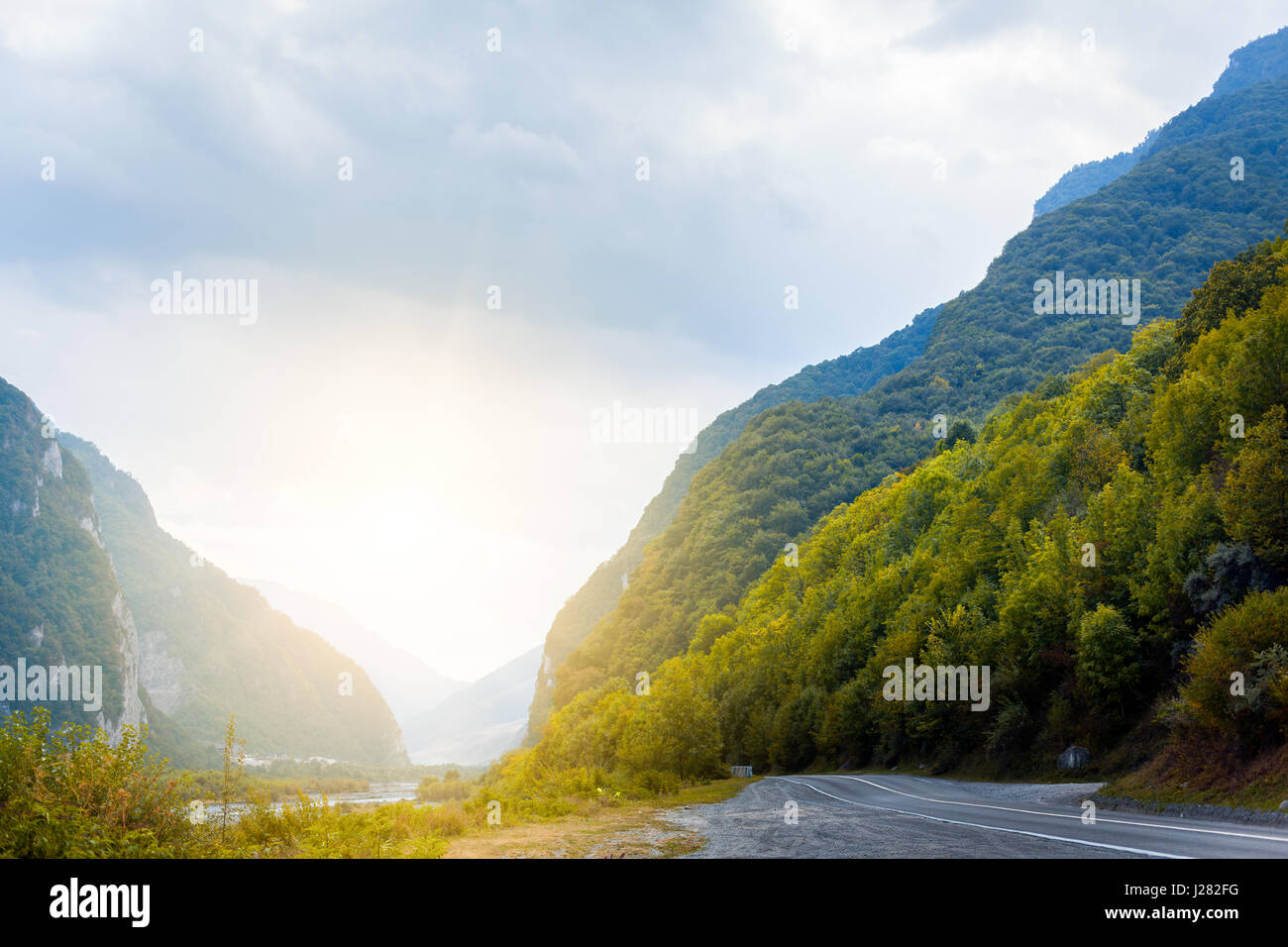 Cinematic road landscape. Asphalt Road throuth the mountains. With ...