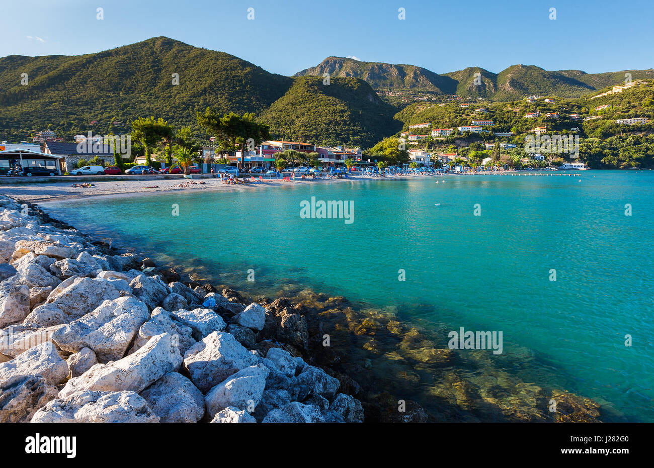 Beautiful beach in Ipsos on Corfu, tourists enjoying a nice summer day ...