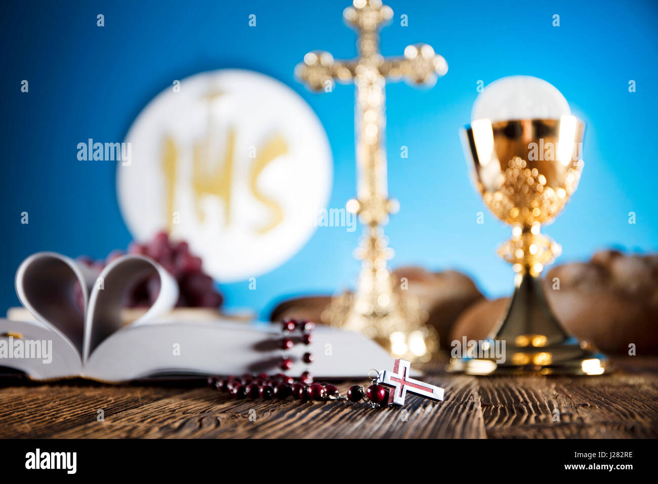 First Holy Communion. Catholic religion theme. Crucifix, Bible, bread ...