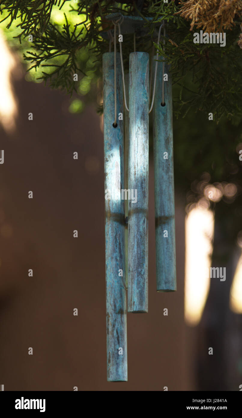Three, weathered wind chime pipes in still serenity along Canyon Road ...