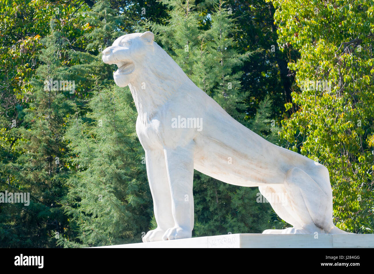 lioness statue in a park of athens Stock Photo - Alamy