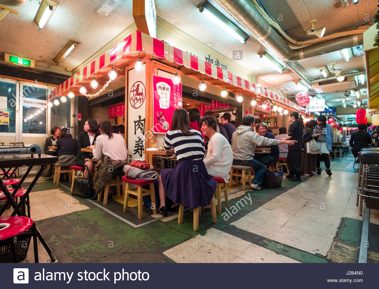 People Sitting Around Tables High Resolution Stock Photography and ...