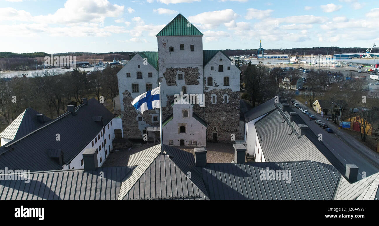 Aerial view of a flag waving infont of Turun linna, the castle of turku ...