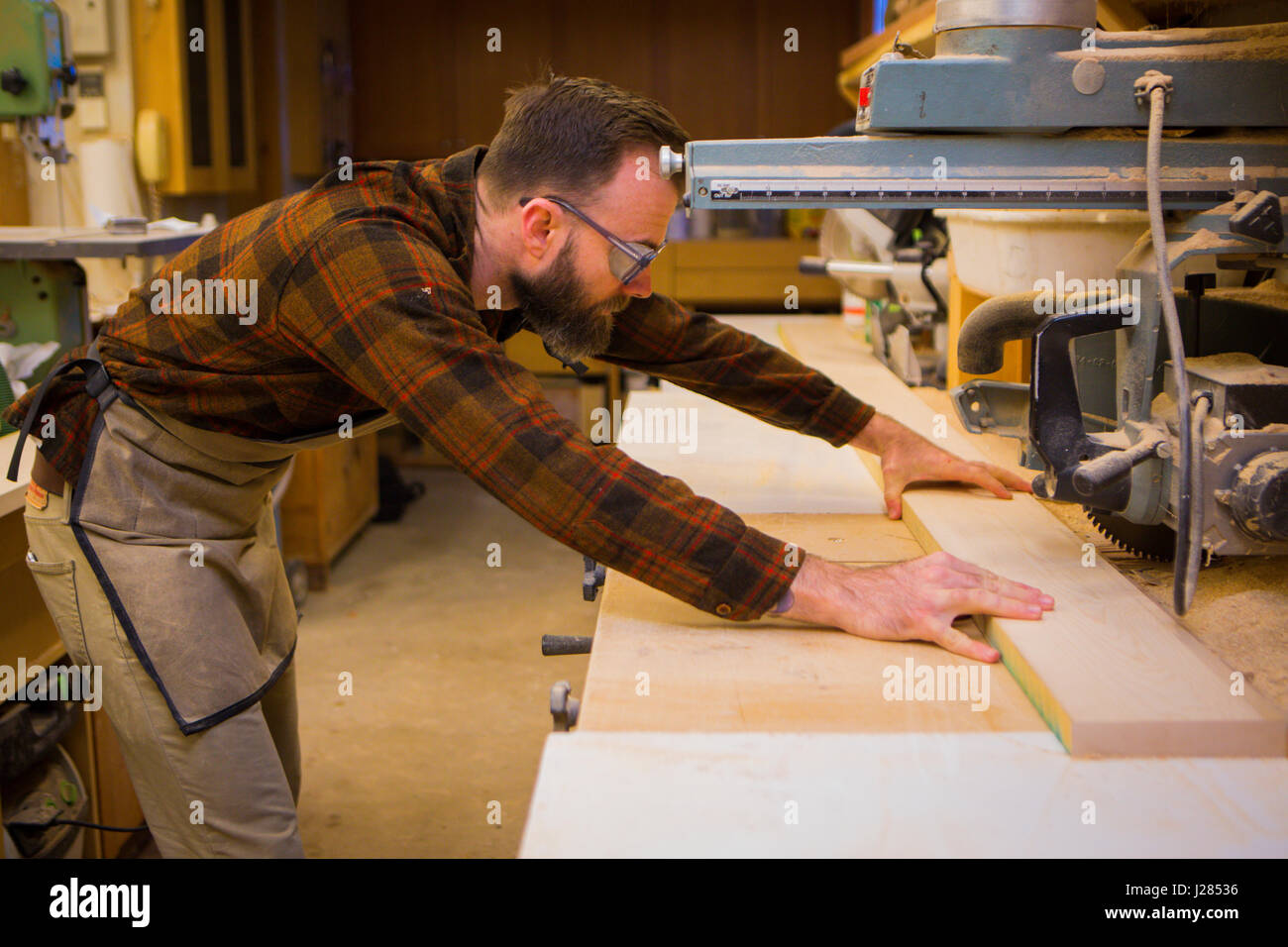 Side view of carpenter working in workshop Stock Photo - Alamy