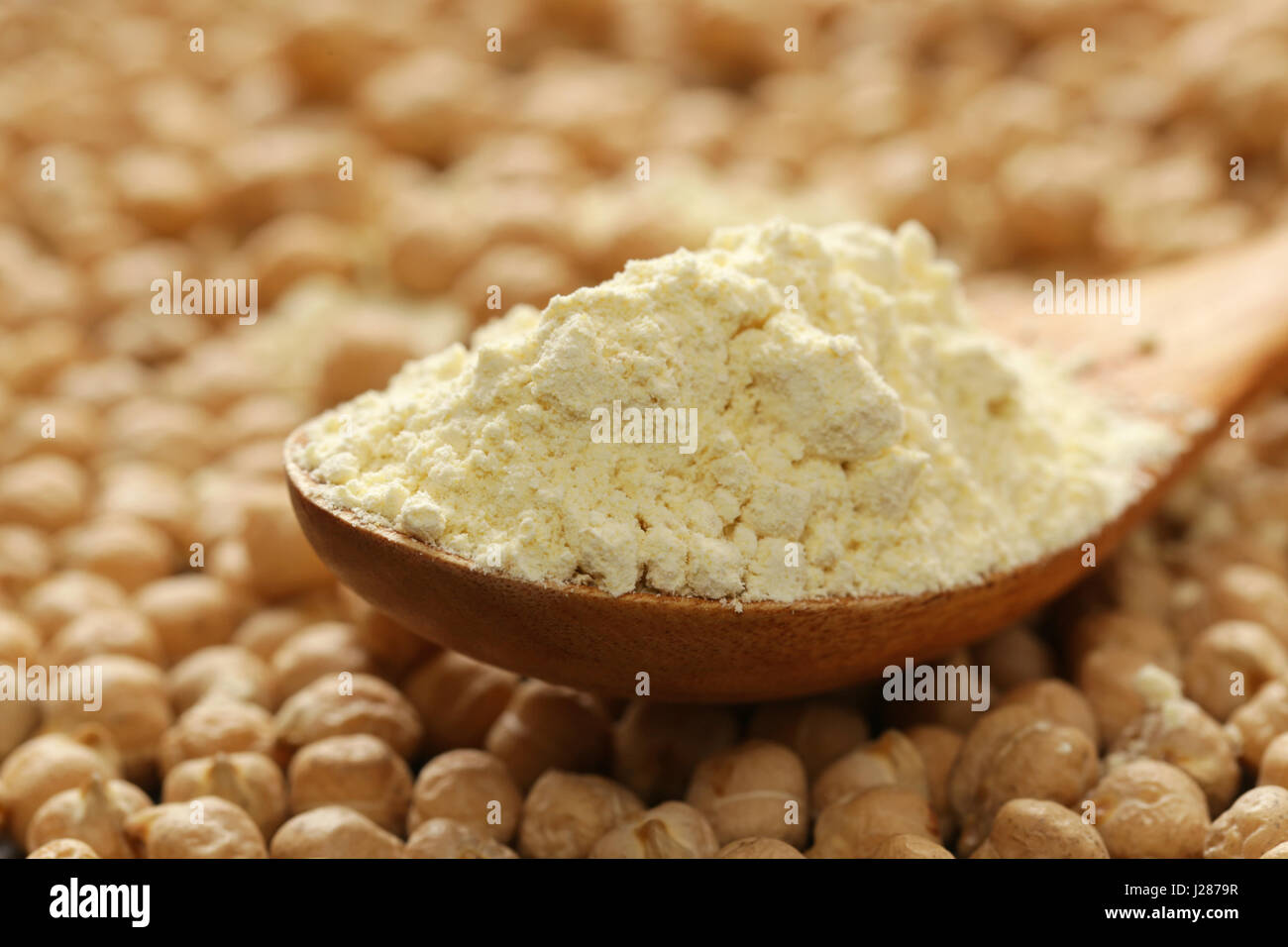 Natural organic chick pea flour in a wooden spoon Stock Photo - Alamy