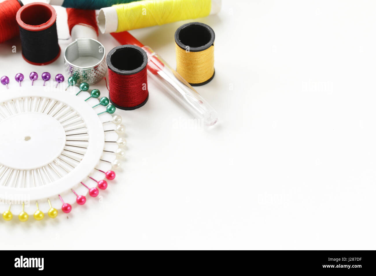 Threads, pins, needles - sewing tools Stock Photo - Alamy