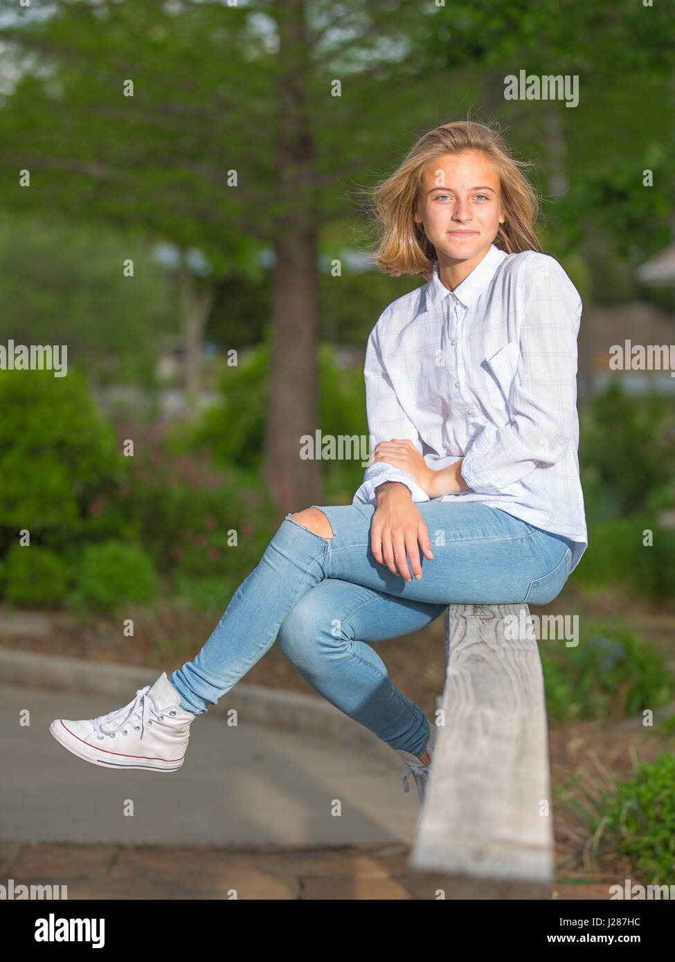 Teen girl sitting on fence hi-res stock photography and images - Alamy