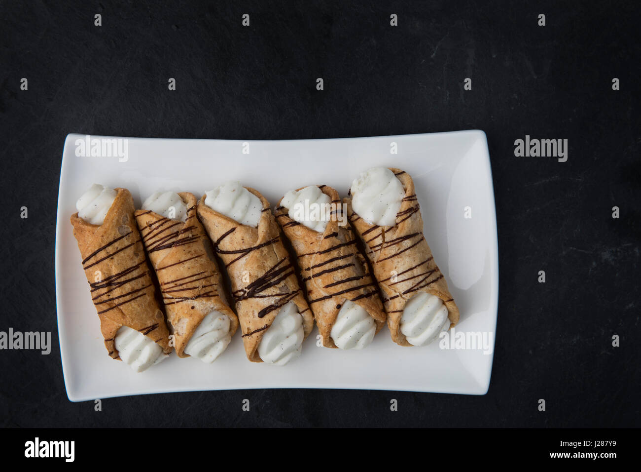 Pastries Stuffed with sweet cream and drizzled with chocolate Stock ...