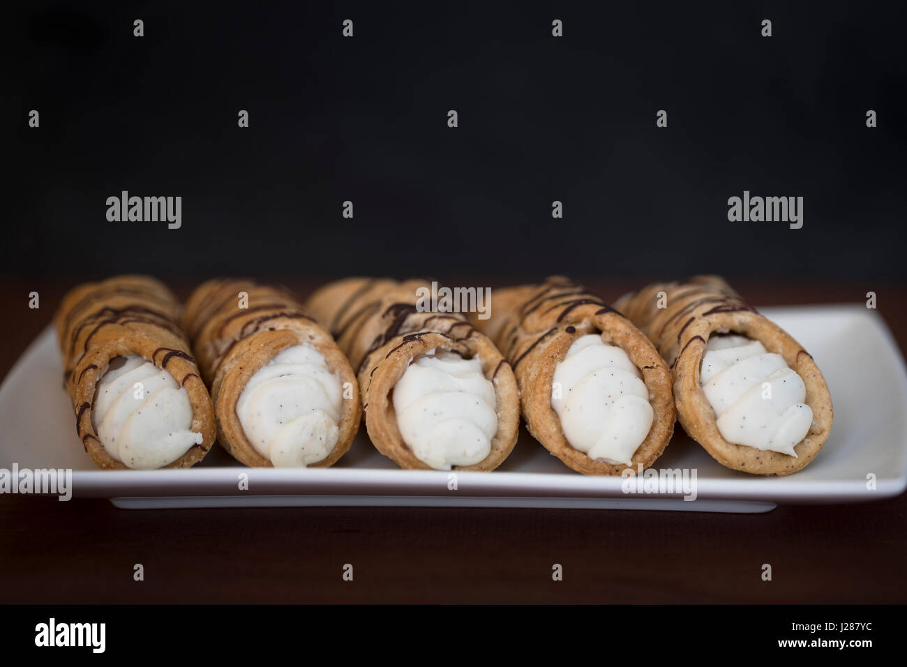 Pastries Stuffed with sweet cream and drizzled with chocolate Stock ...