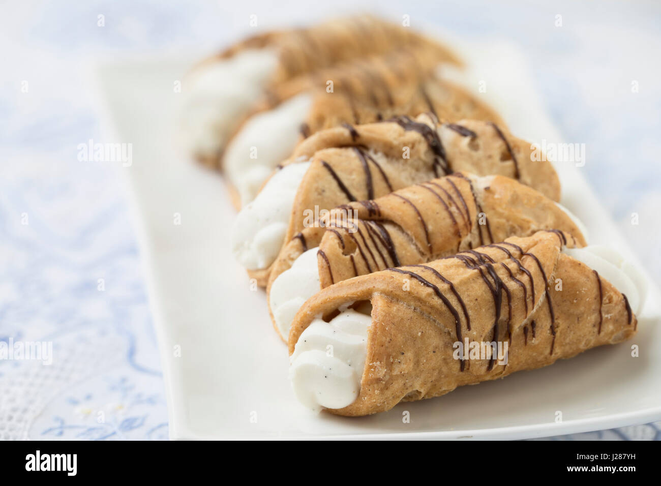 Pastries Stuffed with sweet cream and drizzled with chocolate Stock ...