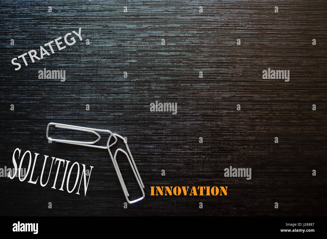 Two connected paper clips on dark background Stock Photo - Alamy