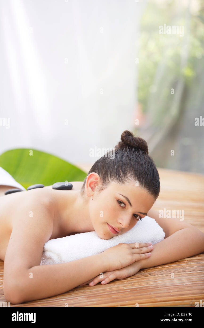 young woman lying on her stomach on a mat Stock Photo - Alamy