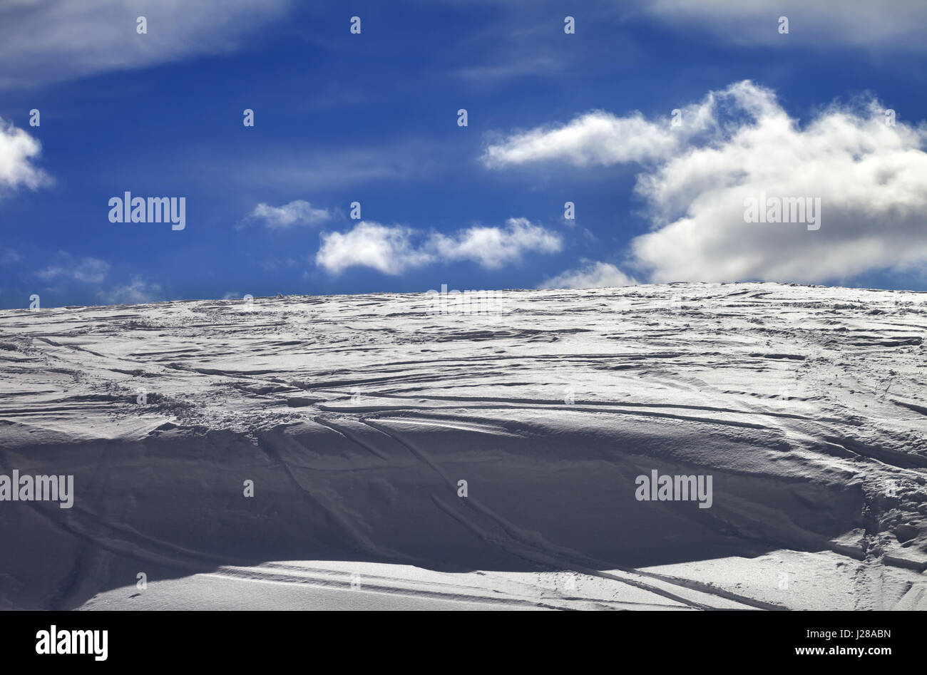 Off-piste slope and snow cornice with track from ski and snowboard in ...