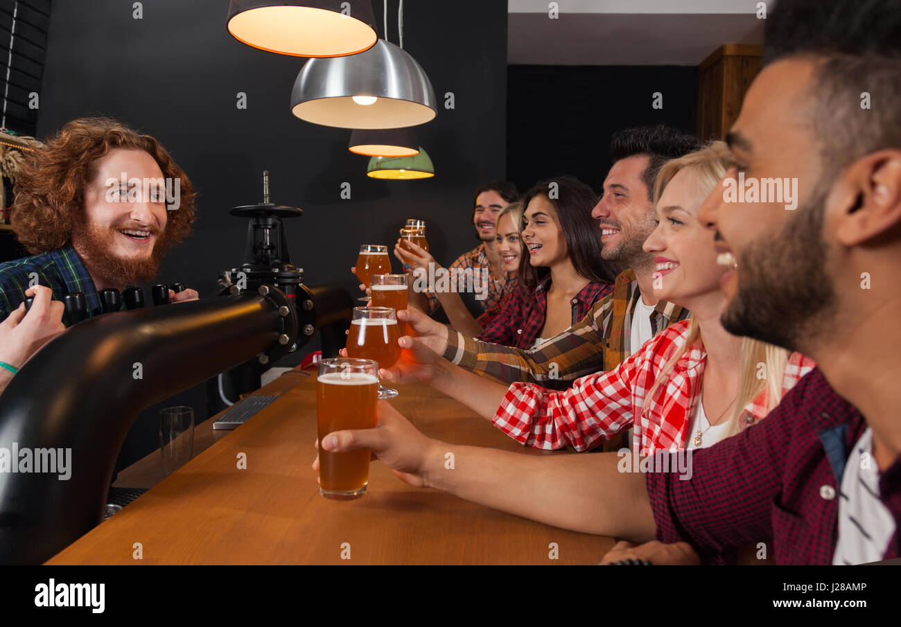 Young People Group In Bar, Barman Friends Sitting At Wooden Counter Pub ...