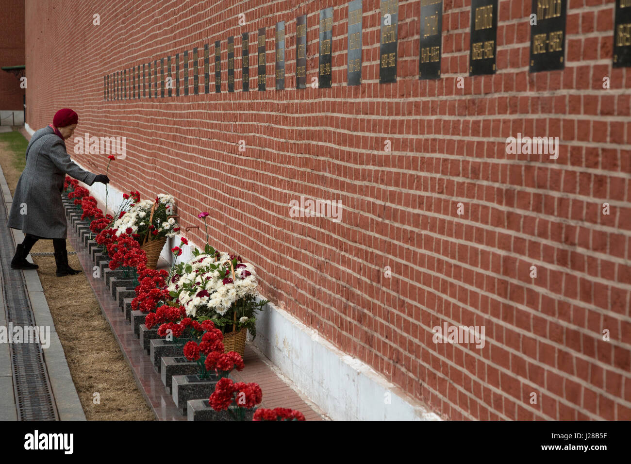Woman lay flowers in hi-res stock photography and images - Alamy