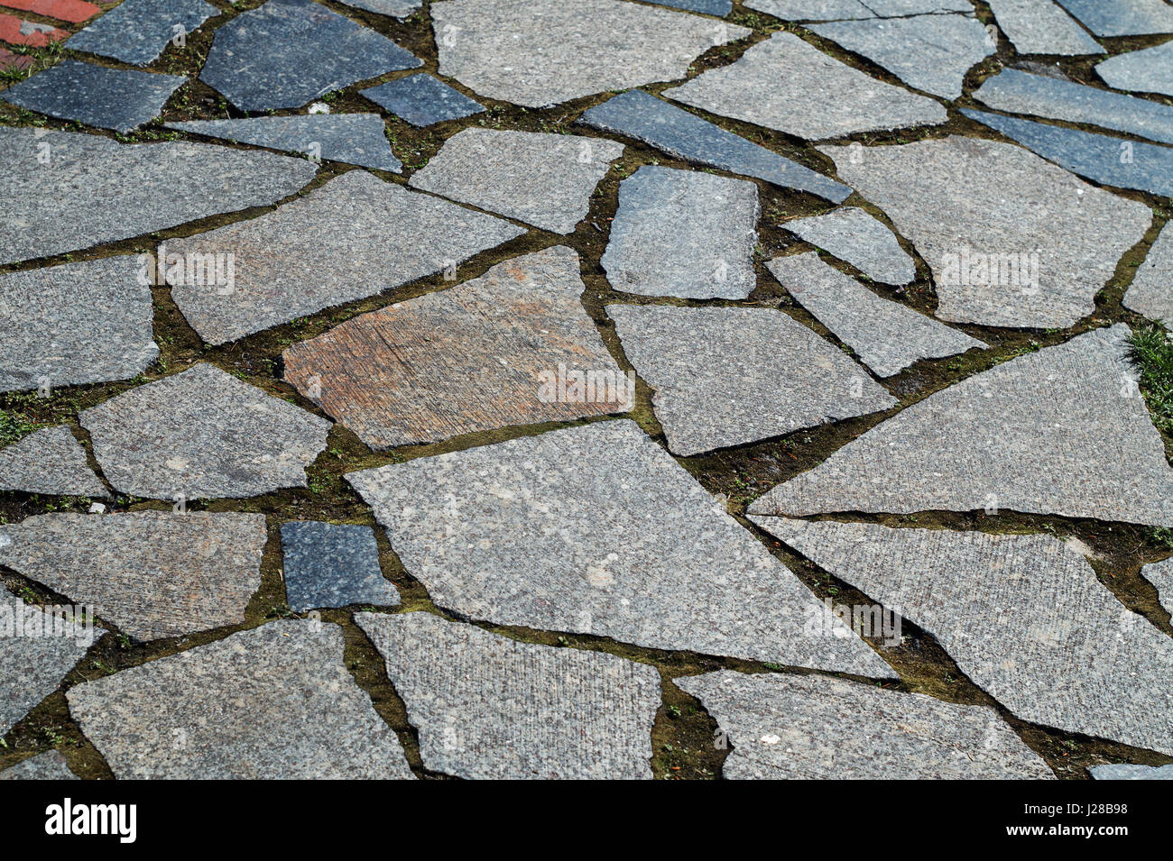 Road surface made of gray granite tiles Stock Photo - Alamy