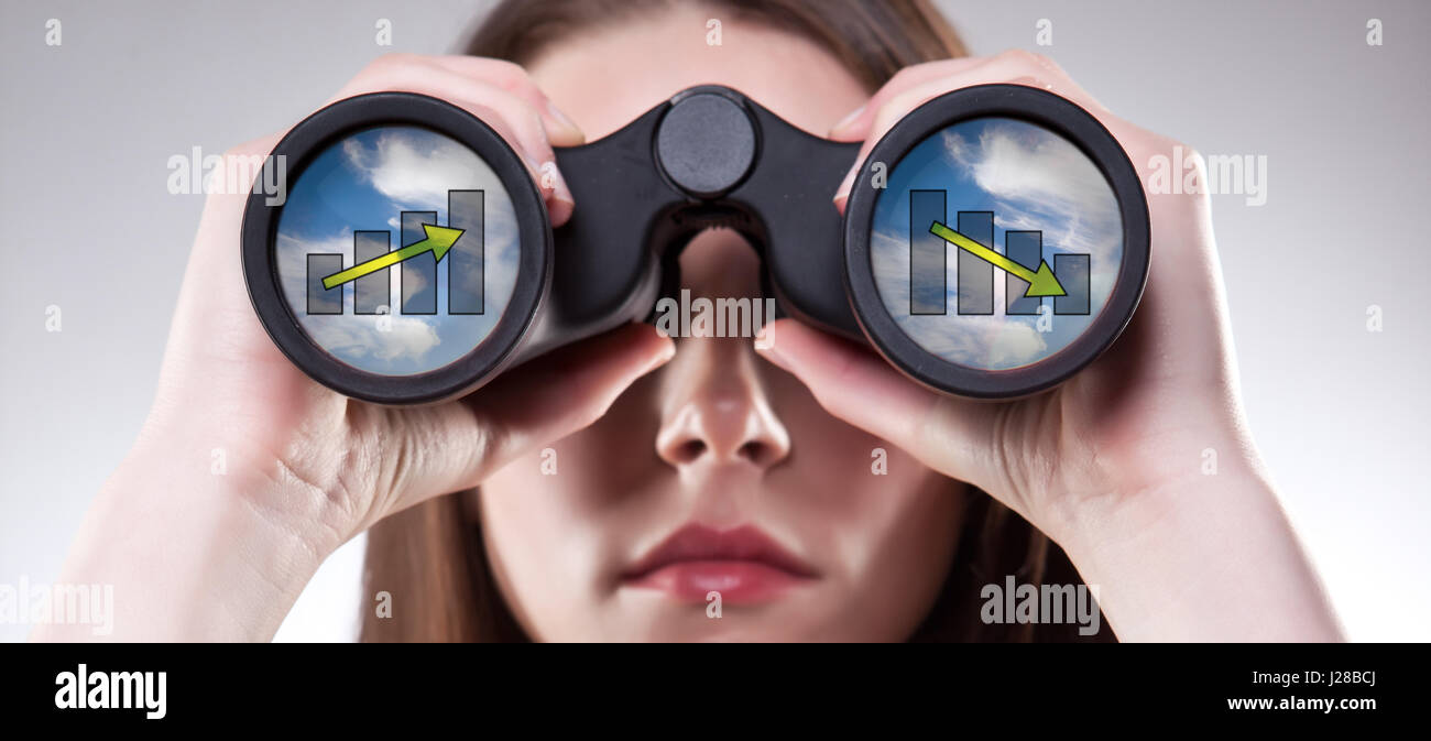 A businesswoman looking through binoculars, seeing conflicting trends ...
