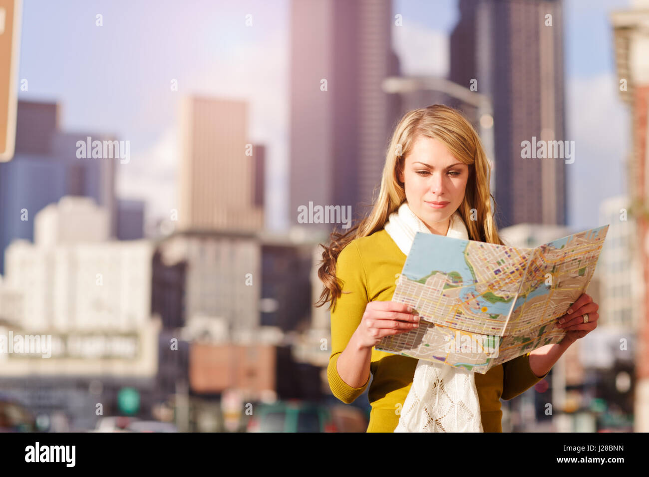 A shot of a beautiful caucasian traveling woman reading a map Stock ...