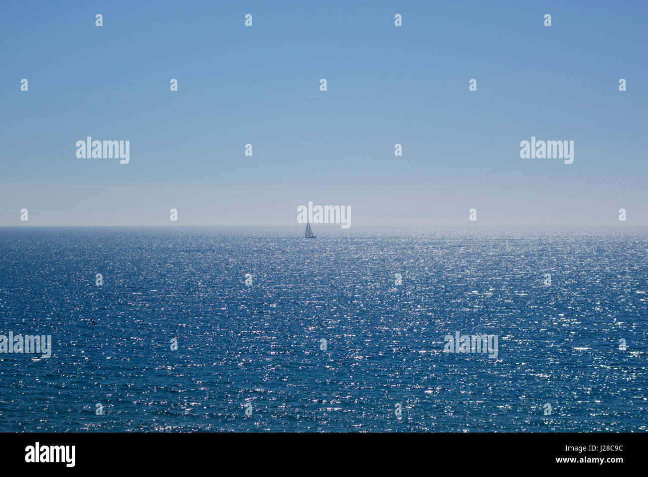 Sailboat in the middle on the sea Stock Photo - Alamy