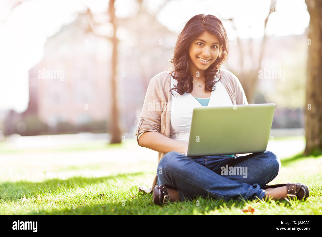 A shot of an asian student using laptop on campus Stock Photo - Alamy