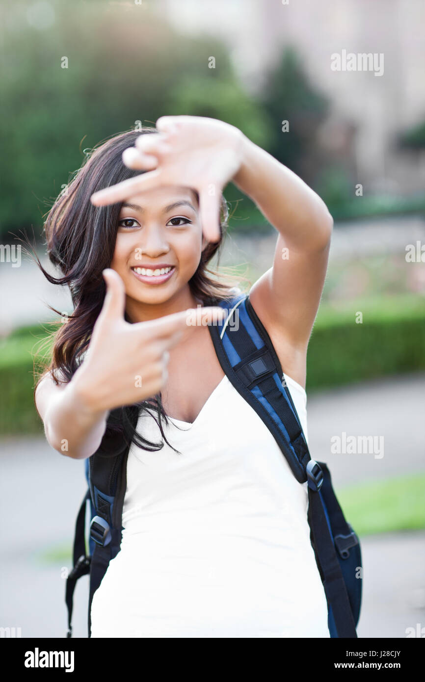 A shot of an Asian student making a frame with her hands Stock Photo ...