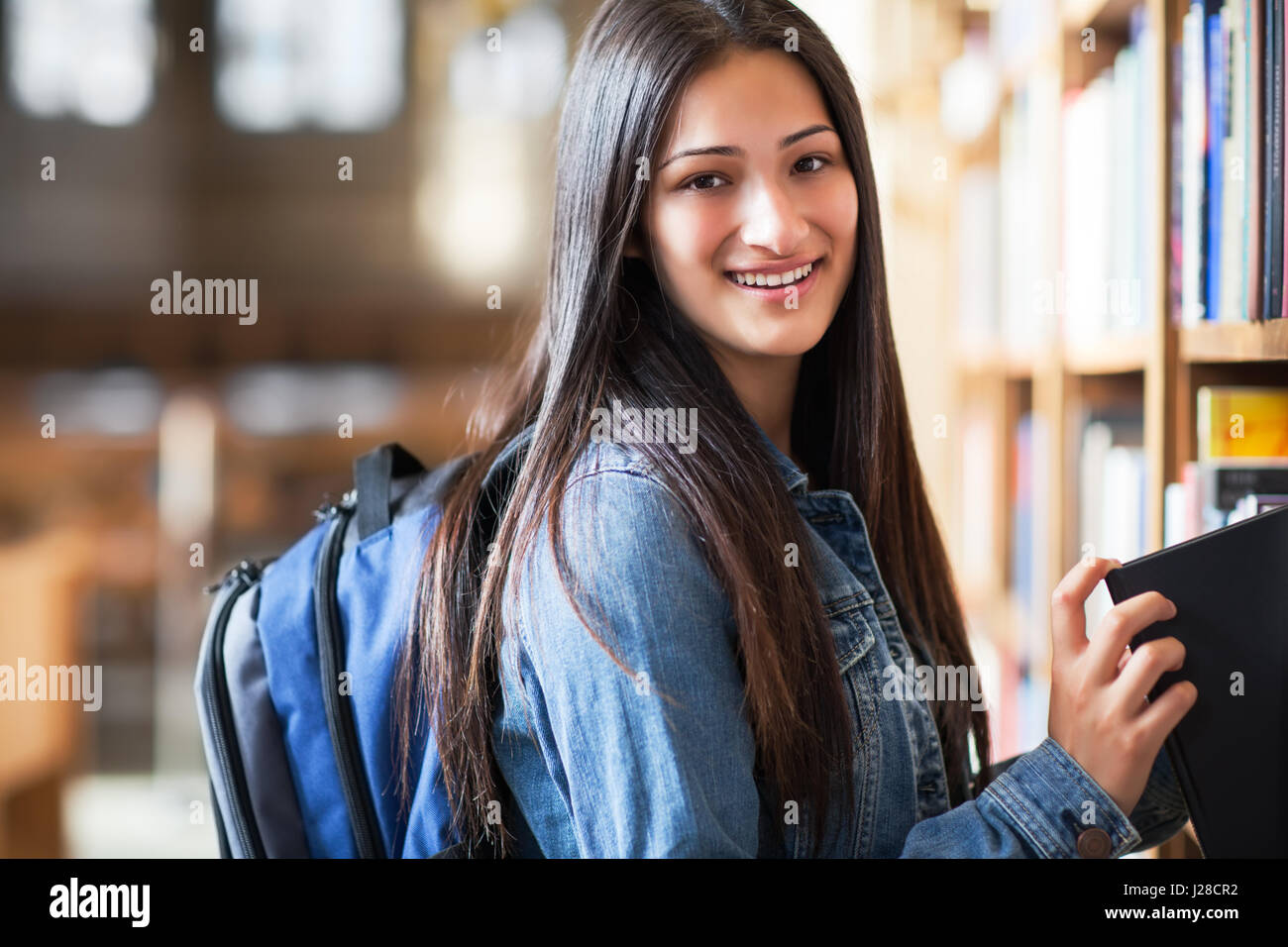 A portrait of an Hispanic college student in the library Stock Photo ...