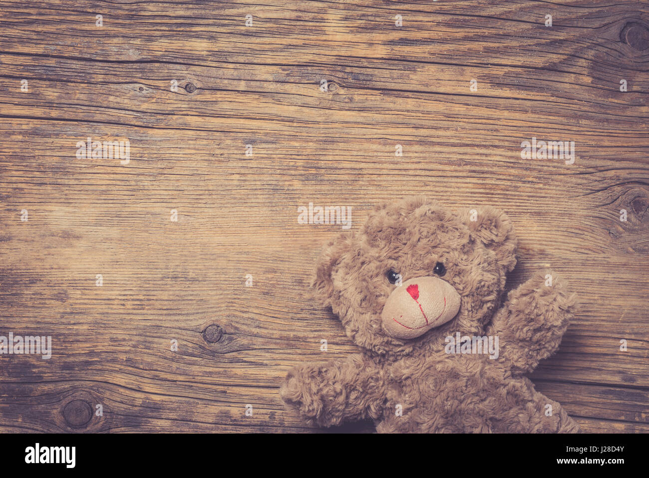 Brown teddy bear over wooden background Stock Photo - Alamy