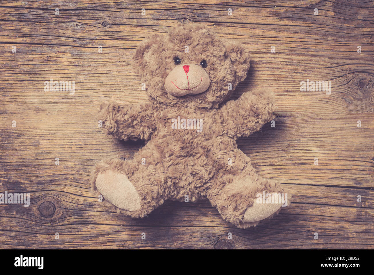 Brown teddy bear over wooden background Stock Photo - Alamy