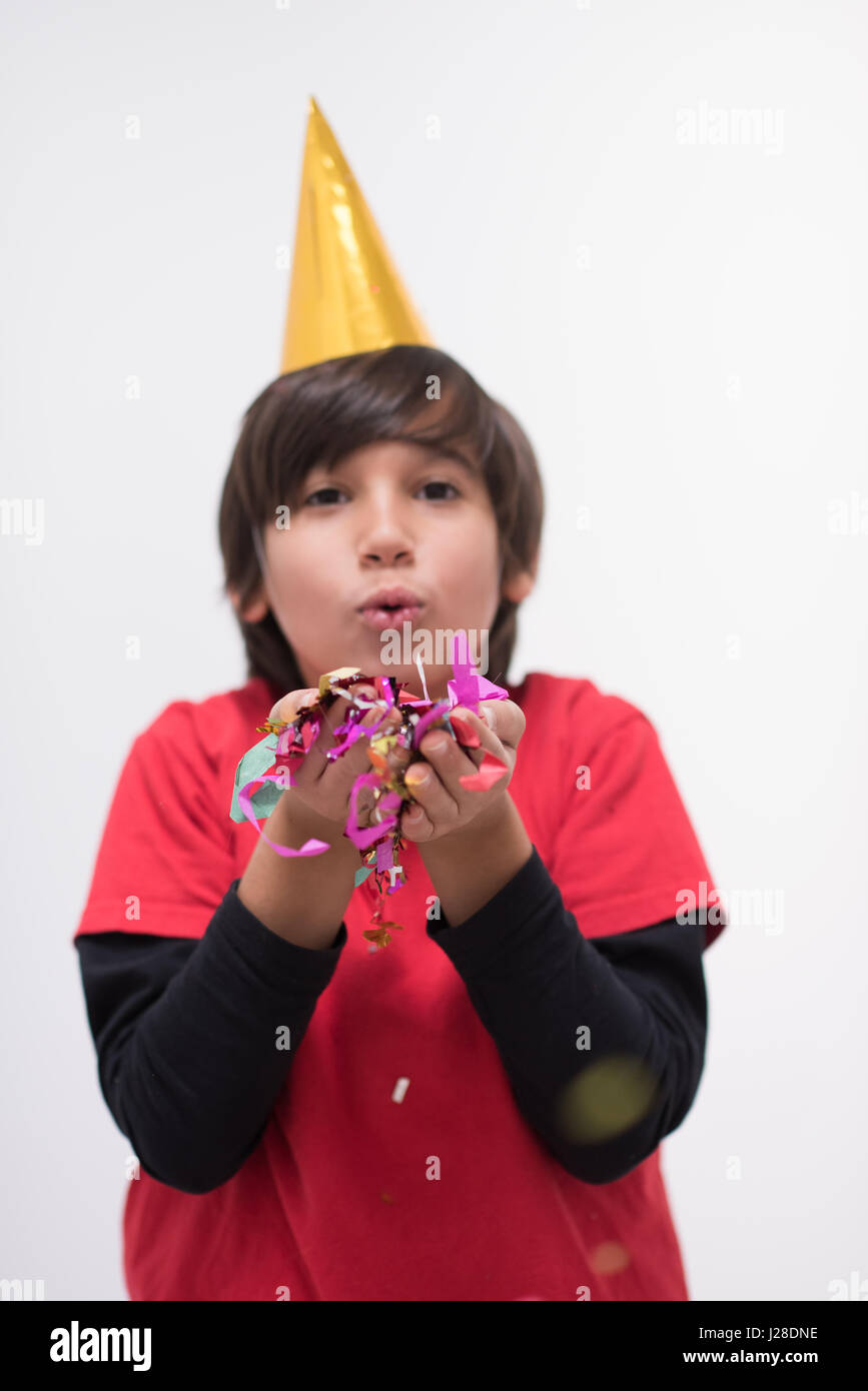 Happy kid celebrating party with blowing confetti Stock Photo - Alamy