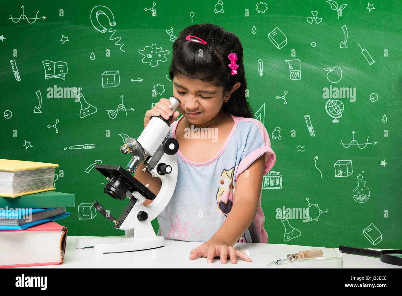 cute indian kids doing science experiment in chemistry lab or biology ...