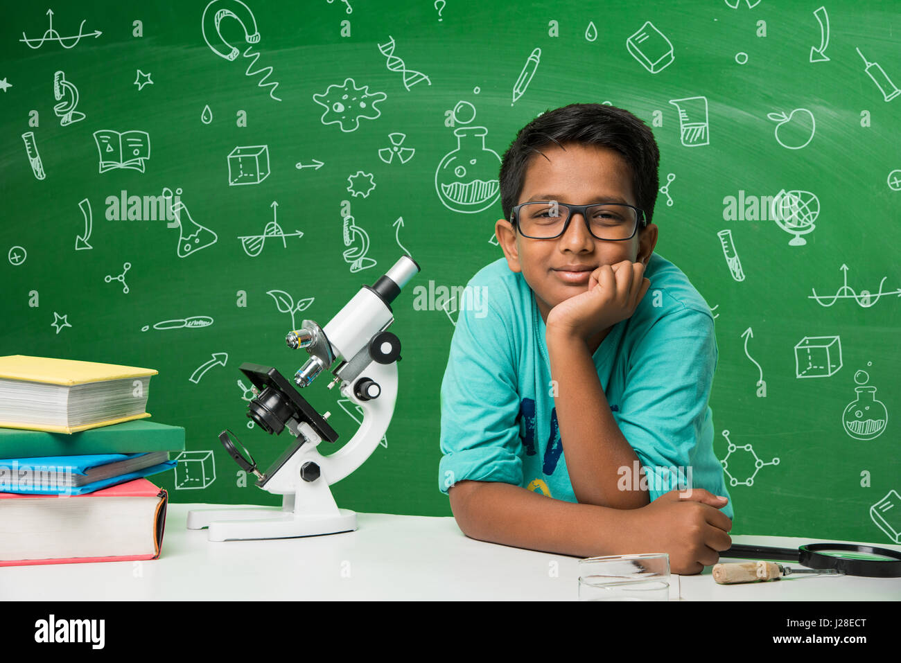 cute indian kids doing science experiment in chemistry lab or biology ...